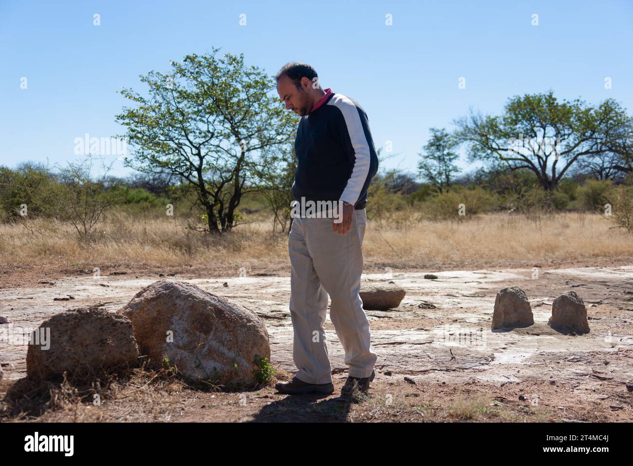 Egyptian arabic man archeologist, geologist studying rocks near a ...