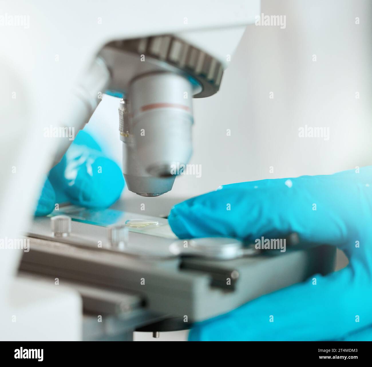 Time to take a closer look. an unrecognisable scientist using a ...