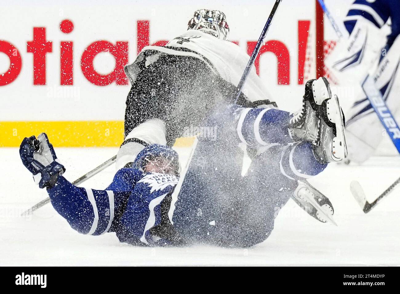Toronto Maple Leafs' Mitchell Marner is left on the ice after a hit by ...