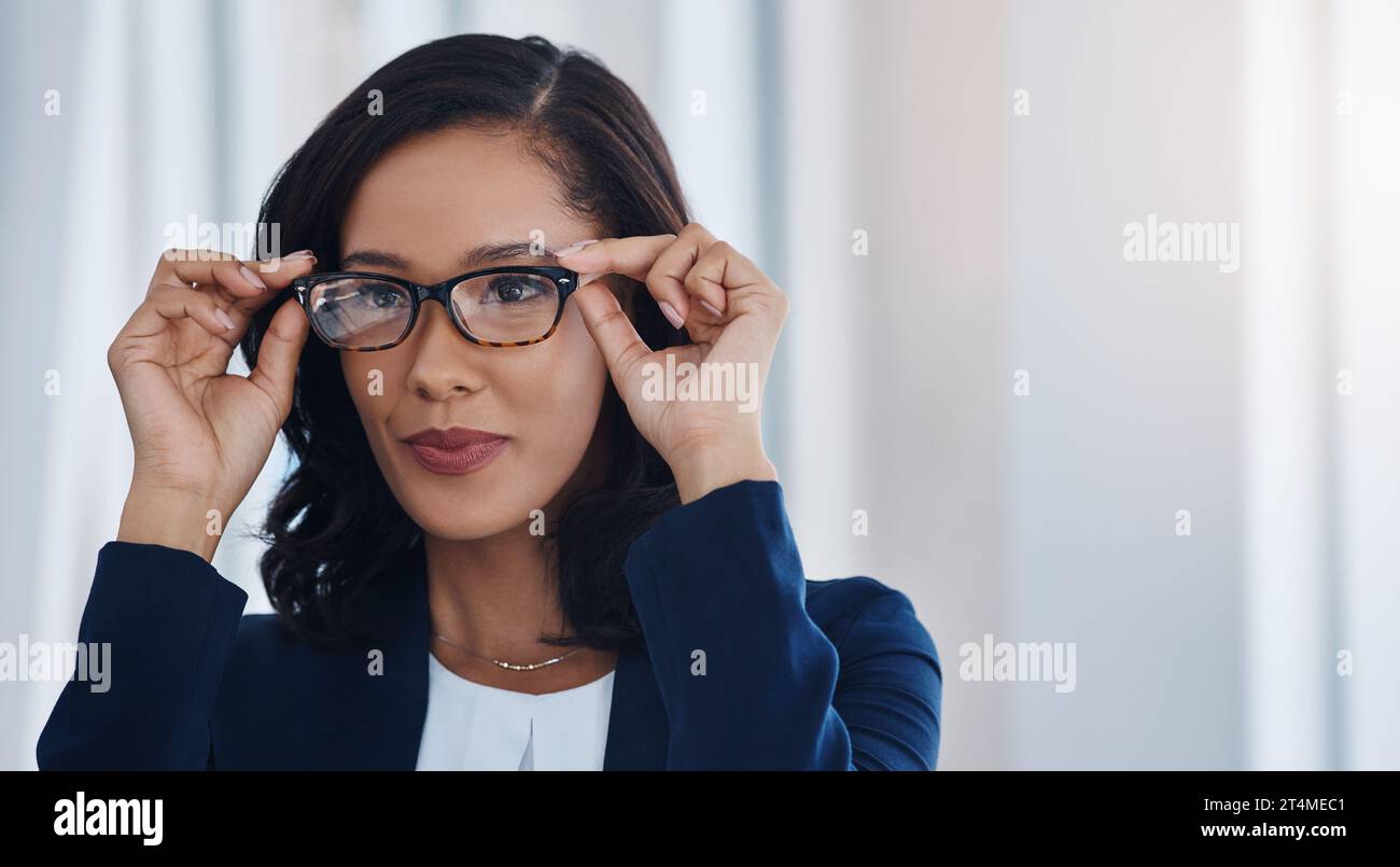 She holds a strong vision for success. a young businesswoman holding a ...