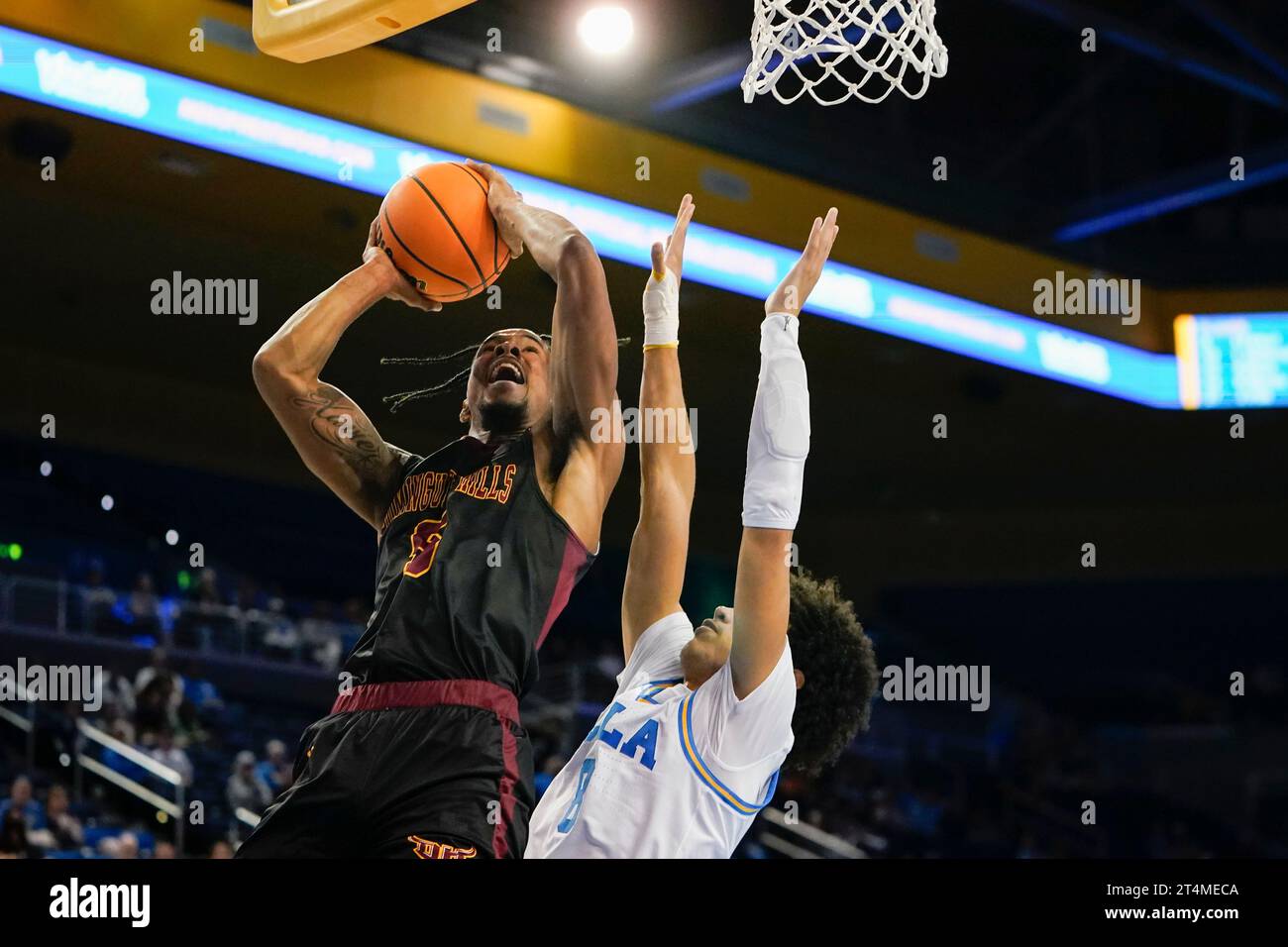 CS Dominguez Hills guard Andre Ball, left, shoots against UCLA guard ...