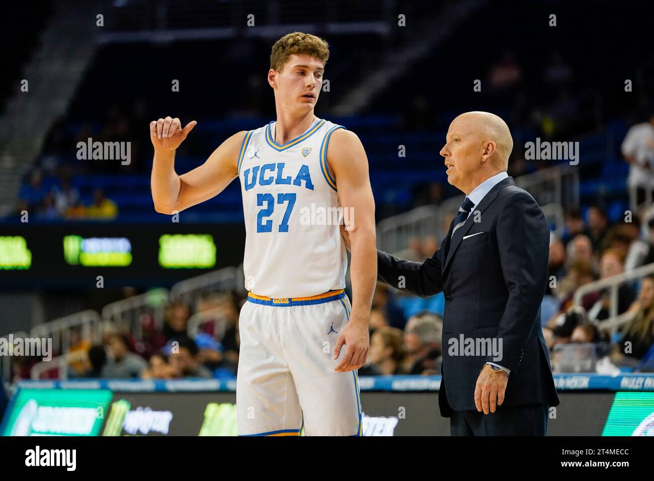 UCLA guard Jan Vide, left, speaks with head coach Mike Cronin during ...