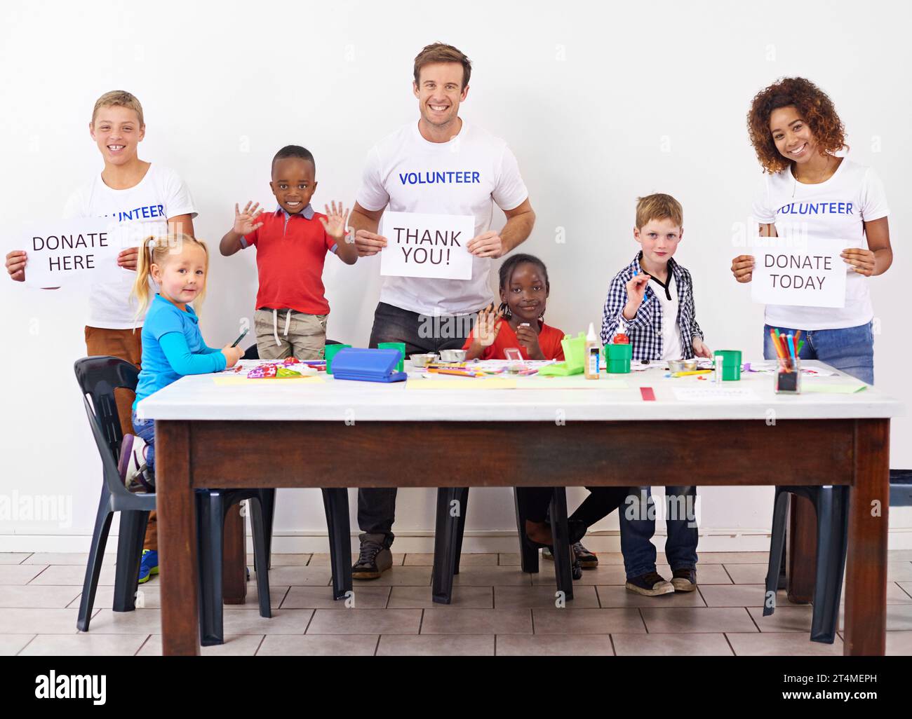 Help us help them. Portrait of volunteers holding up signs while ...