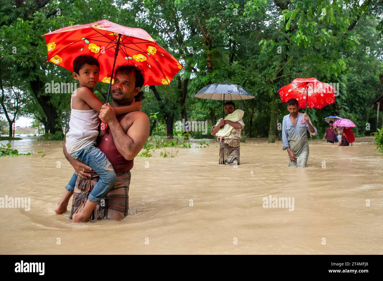 People walking through floodwater, Satkania Upazila, Bangladesh Stock Photo - Alamy