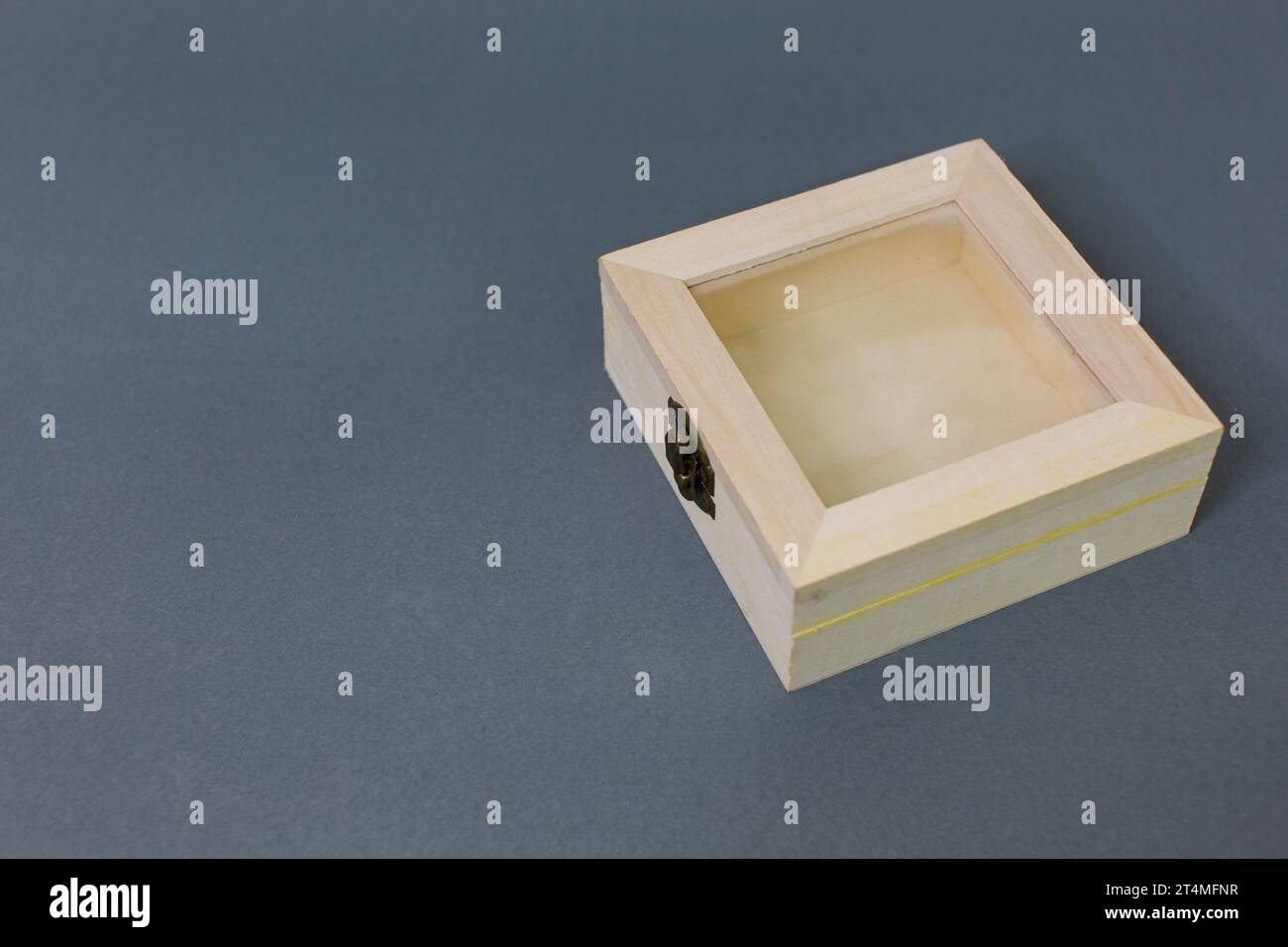 Empty small light brown wooden box Container objects are locked with ...