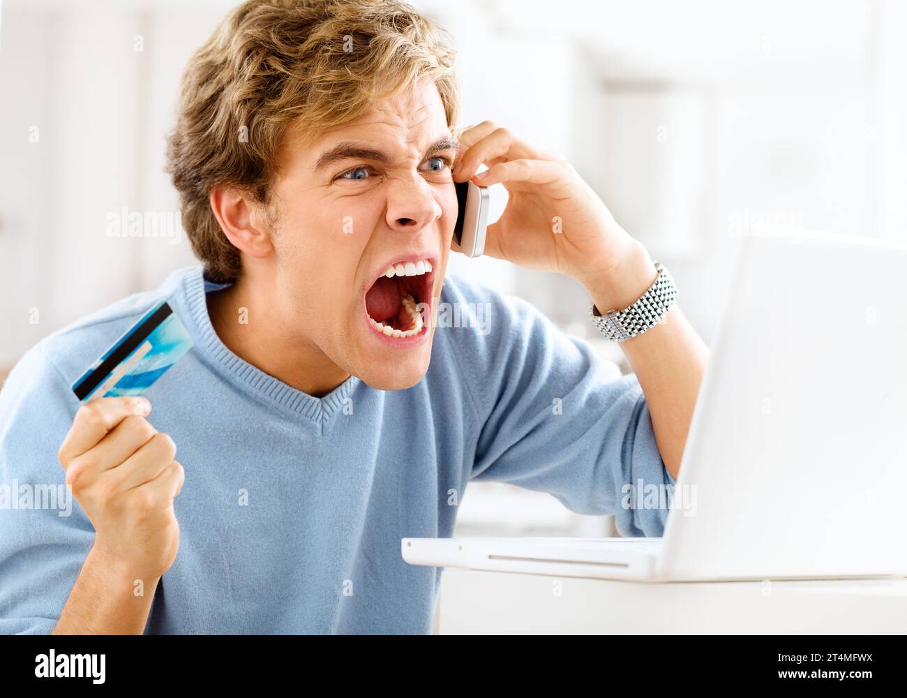 Double deductions ruining his day. a young man making an angry phone ...
