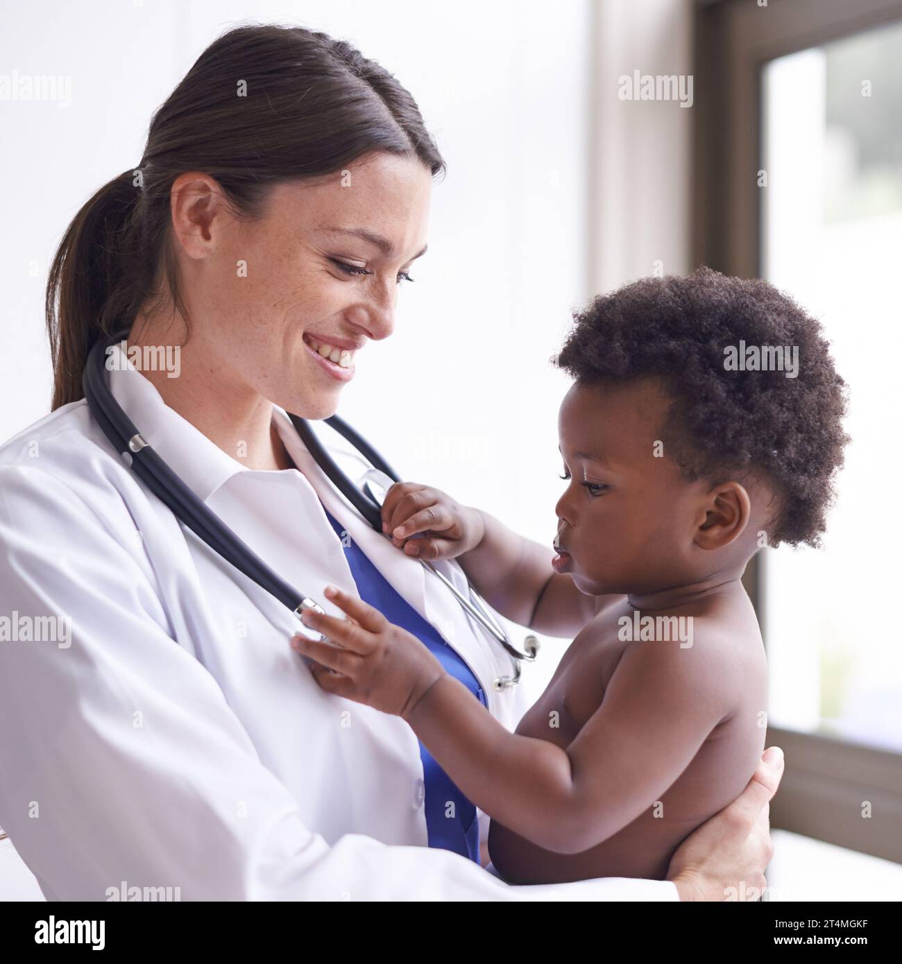 Just in for a routine pediatric checkup. a female pediatrician doing a ...