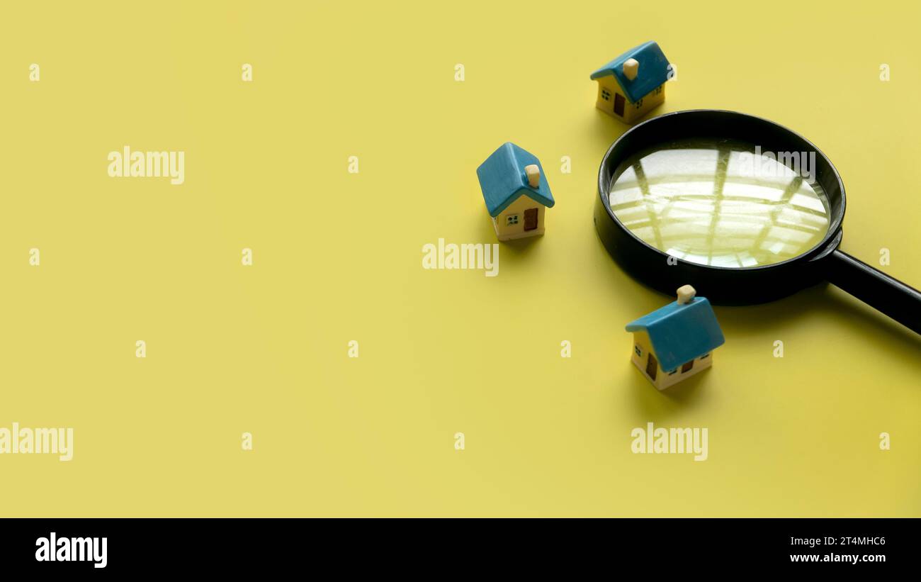 House searching concept. House inspection. Miniature house with ...