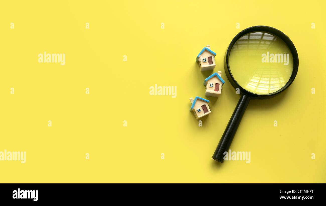 House searching concept. House inspection. Miniature house with ...