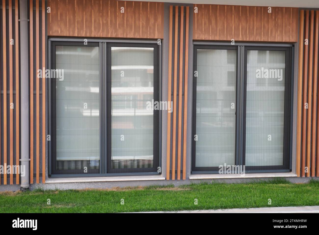 Modern front window with thin curtains and house walls from the outside ...