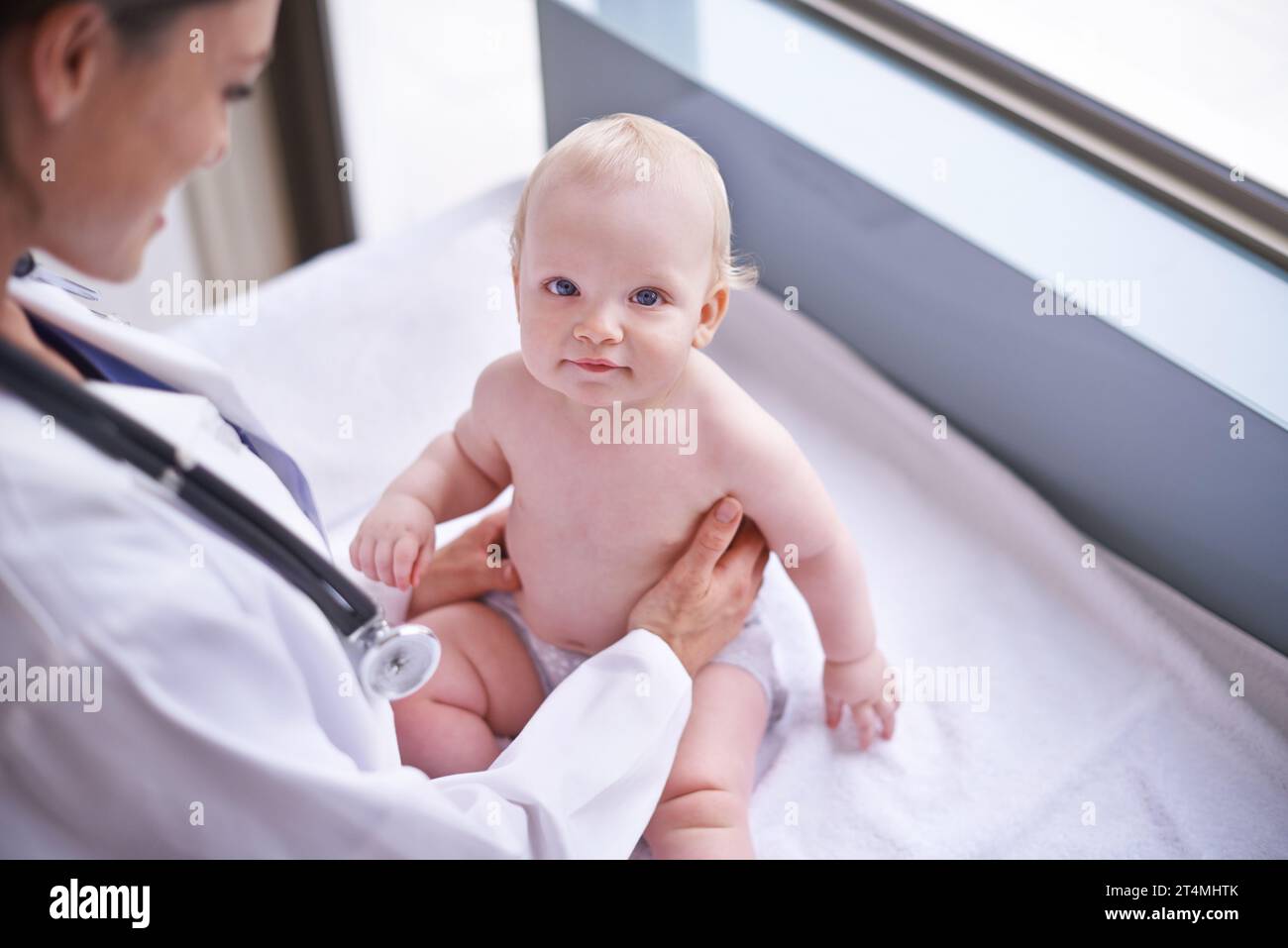 Having his very first checkup. a female doctor doing a checkup of a ...