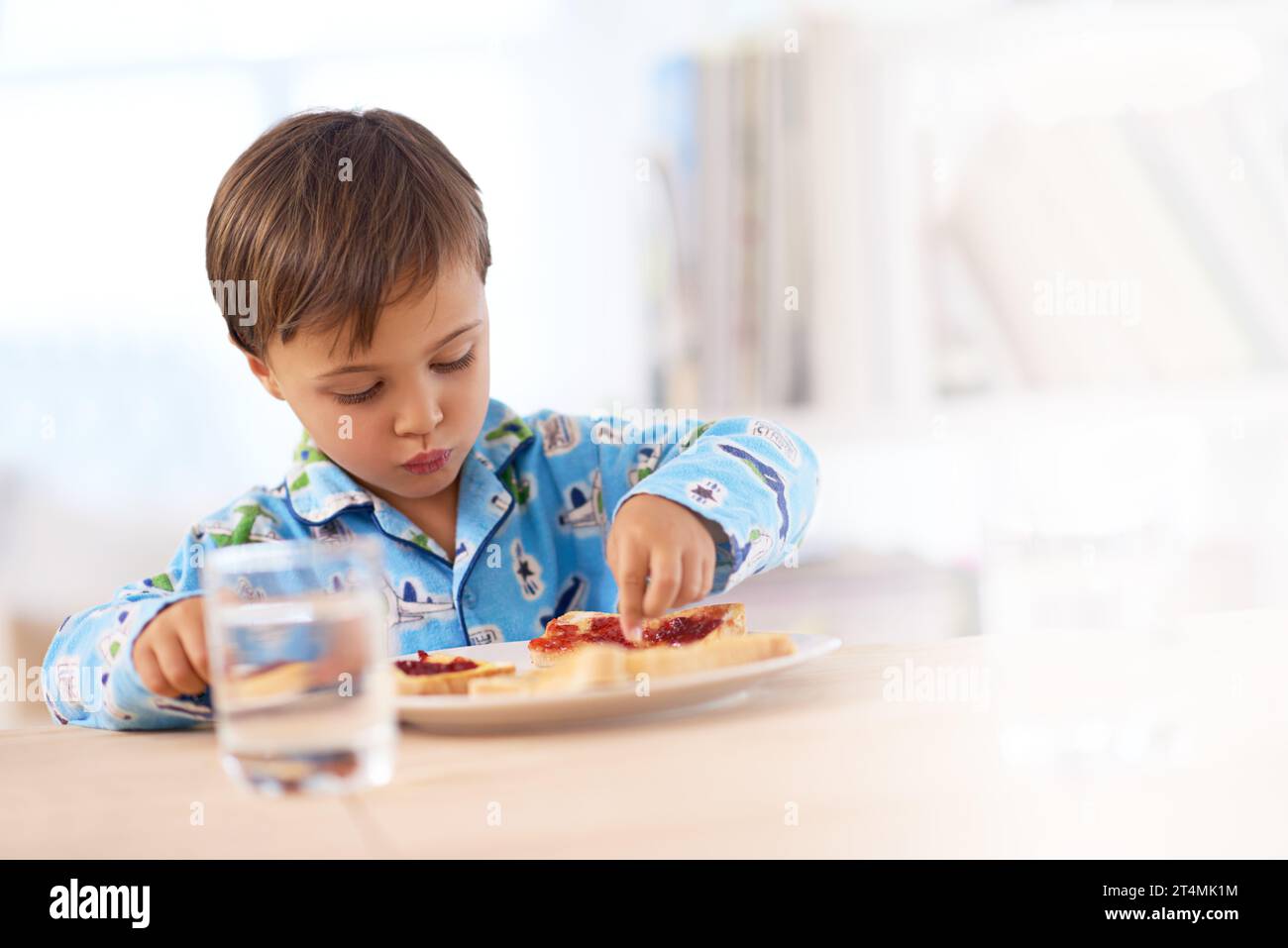 Time to get my breakfast on. A cute little boy eating breakfast Stock ...