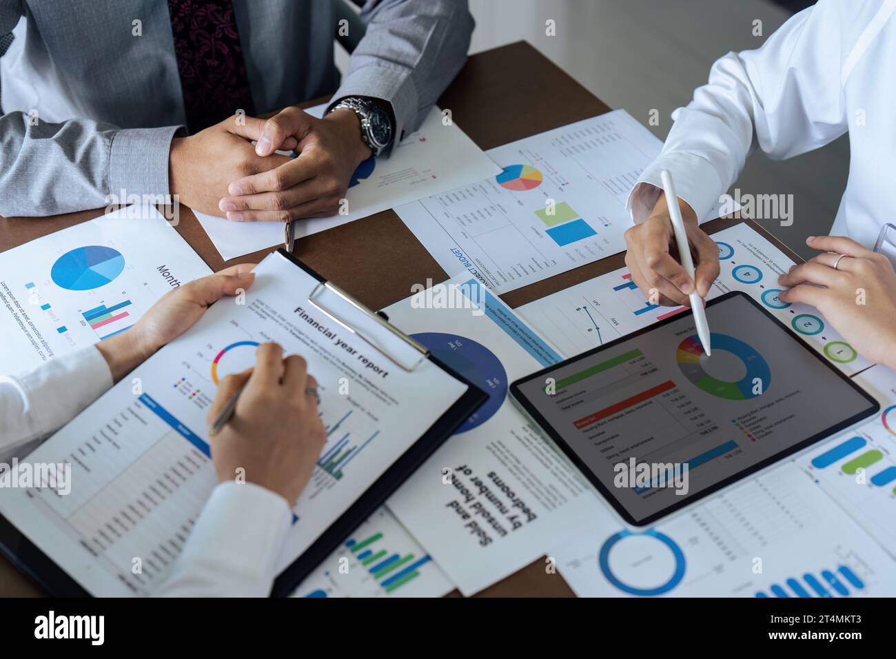 Business people teamwork with analysis cost graph on desk at meeting ...