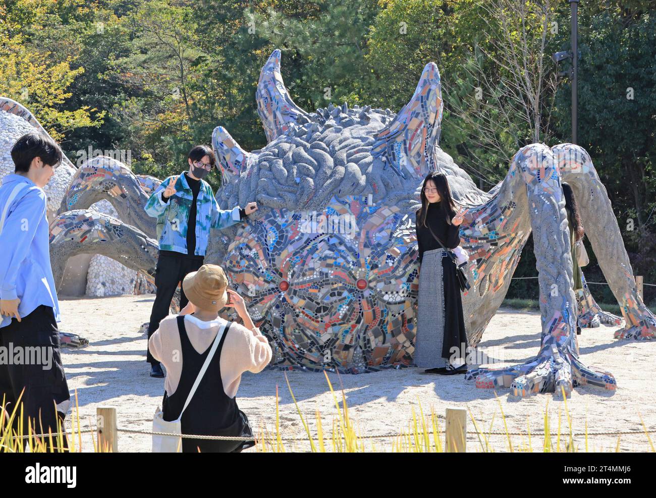 Visitors snap photos in front of a Tatari-gami curse god statue on Nov ...