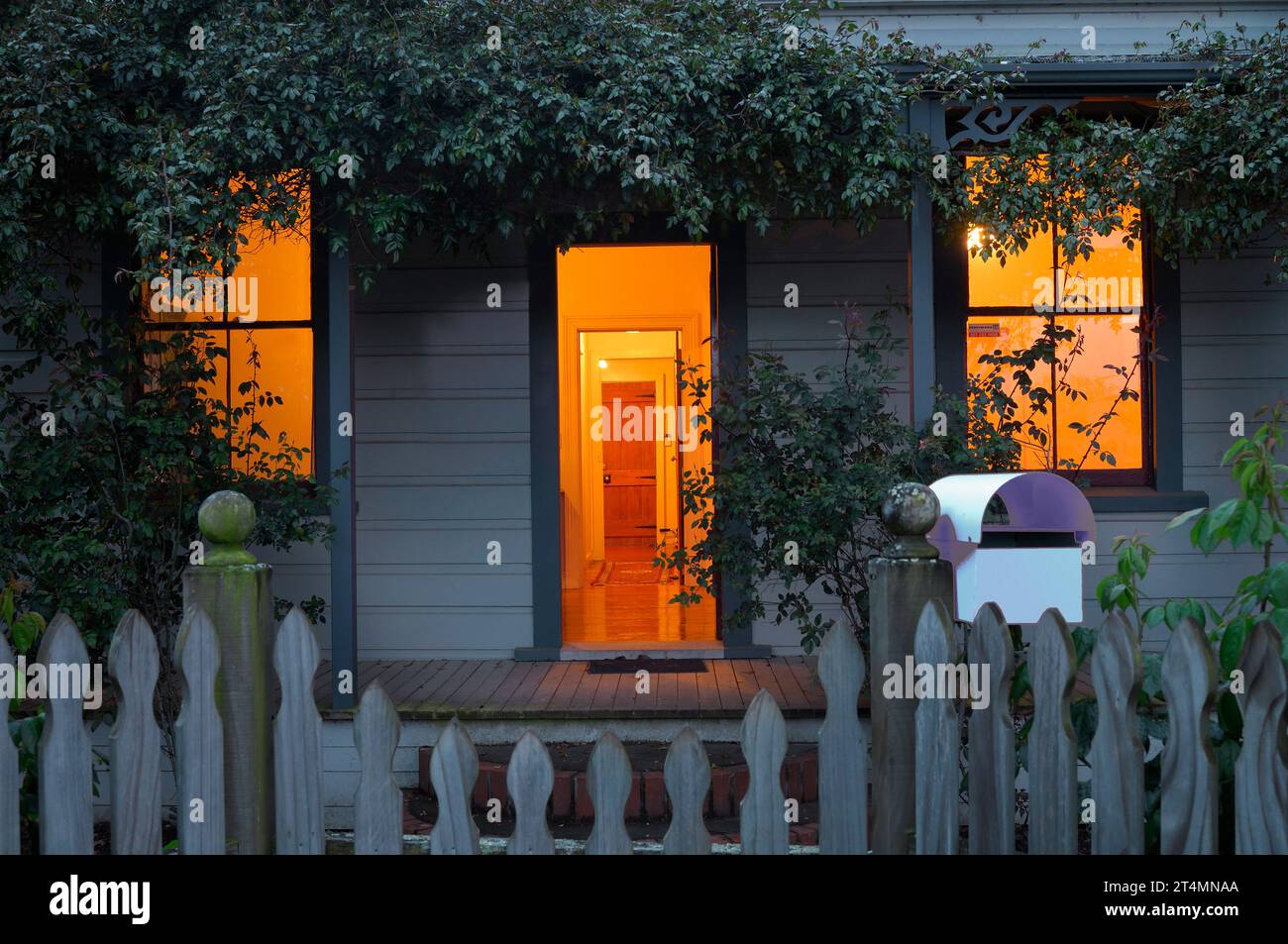 Lights on in old cottage at night Stock Photo - Alamy