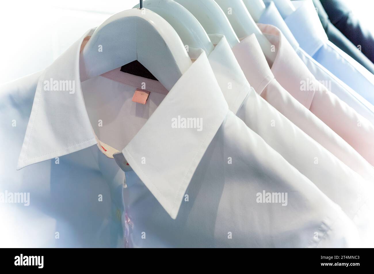 Rack of mens formal business shirts on clothes hangers Stock Photo - Alamy