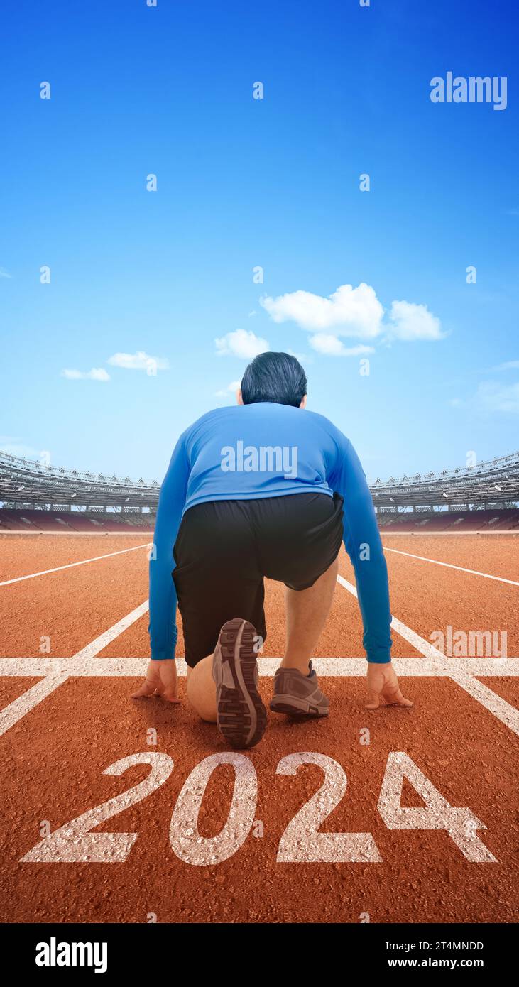 Rear view of runner man ready to run on the 2024 line. Happy New Year ...