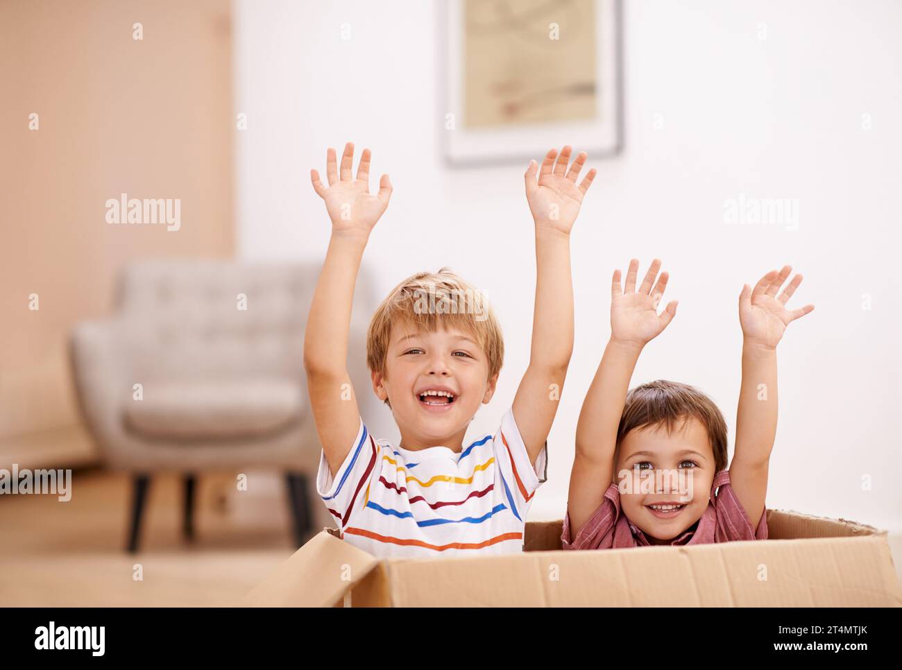 Lets give mom the best present. Two young brothers raising their arms ...