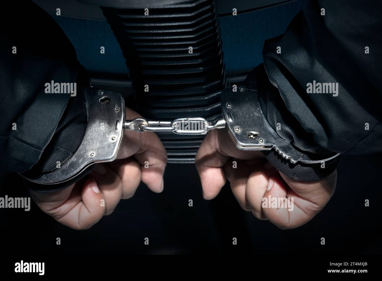 The man was sitting on a chair with tied hands in handcuffs. Violence ...