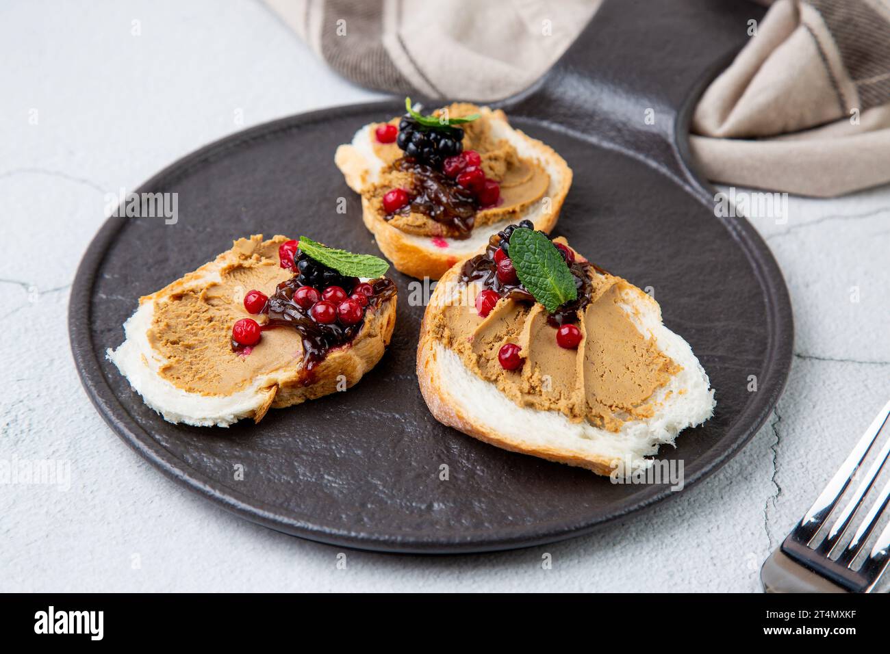 canapes with pate, mint leaves and berries, side view Stock Photo - Alamy