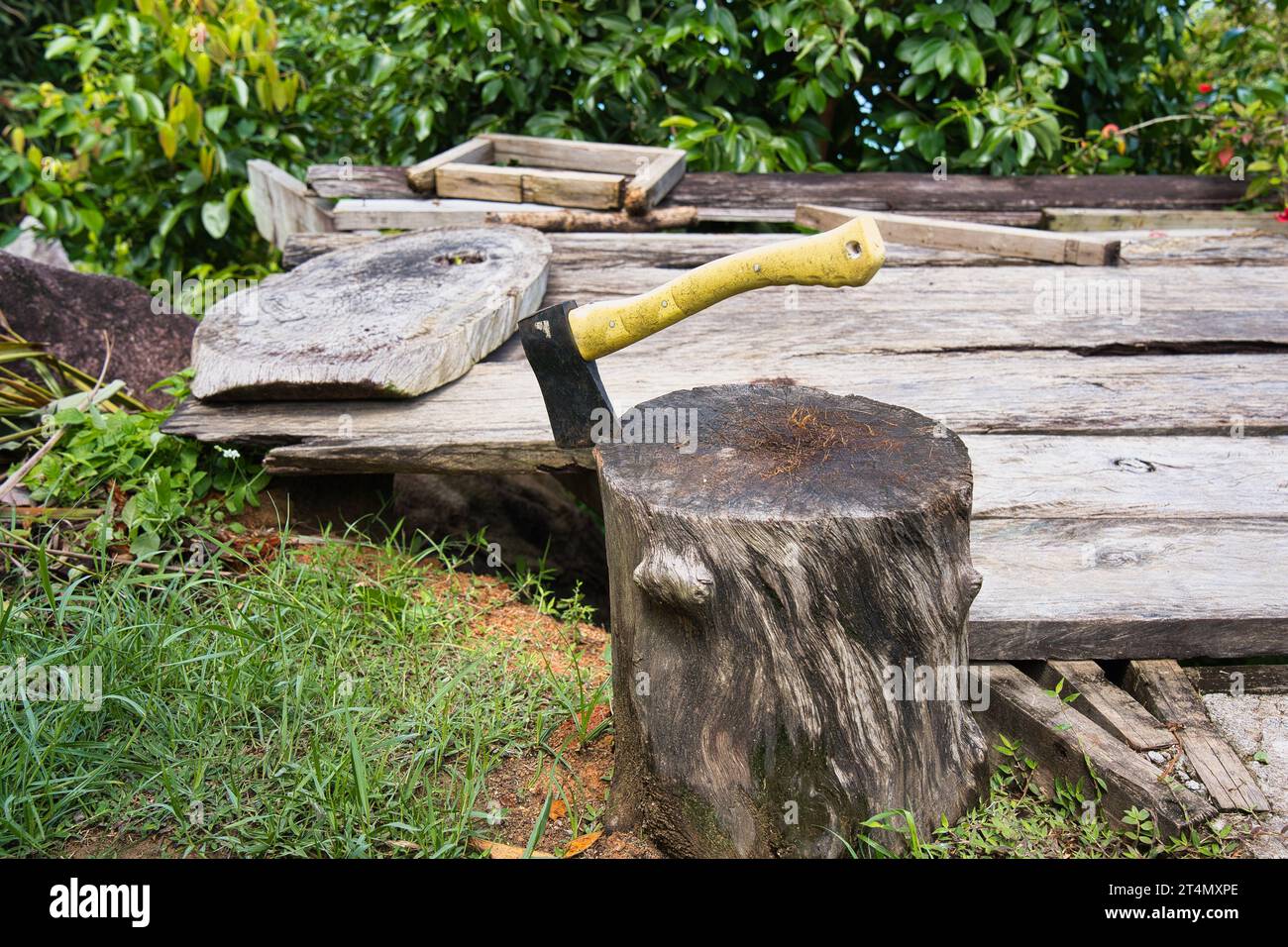 Yellow handle axe on wood for cutting wood Stock Photo - Alamy