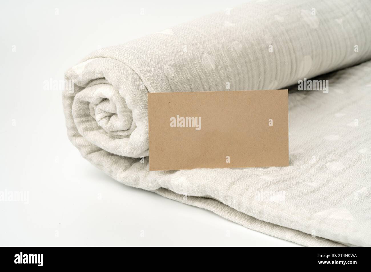 Warm cotton muslin blanket with paper tag on white background Stock ...