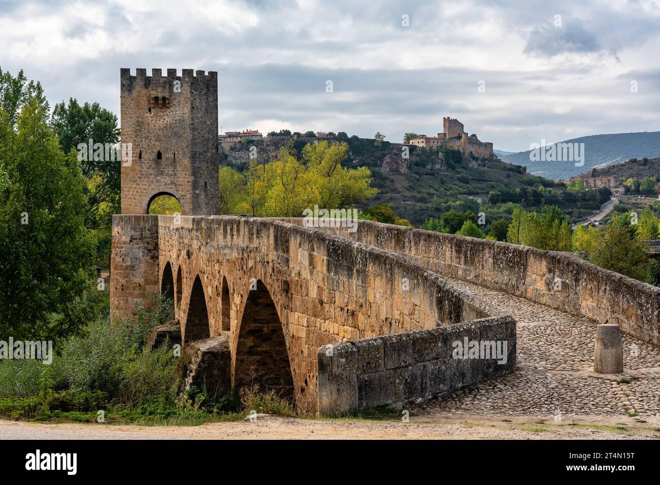 Medieval stone bridge that spans over the river that runs through the ...