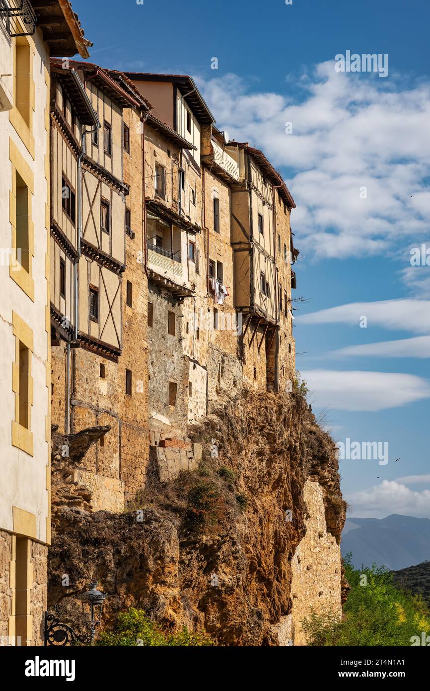 Houses perched on the cliff atop the hill of the medieval village of ...