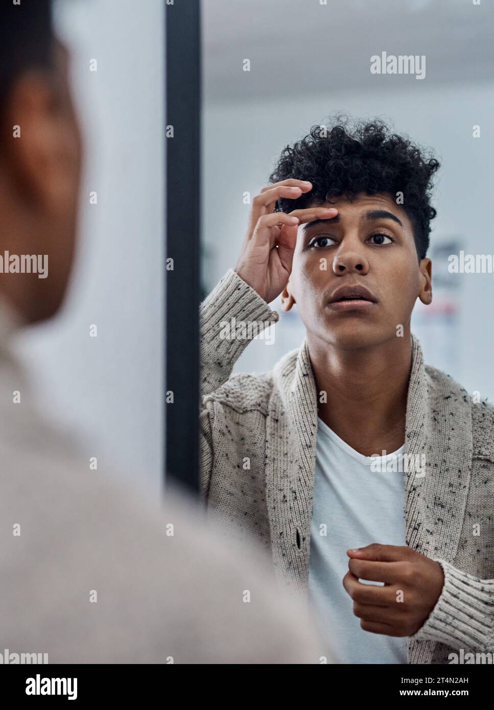 Dont be afraid to get your brows down. a handsome young man inspecting ...