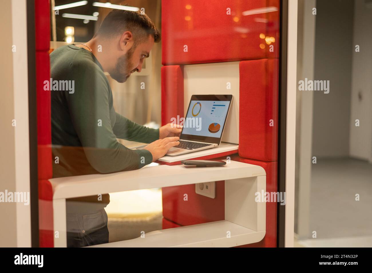 A bearded man in a booth for online negotiations. Privacy booth Stock ...