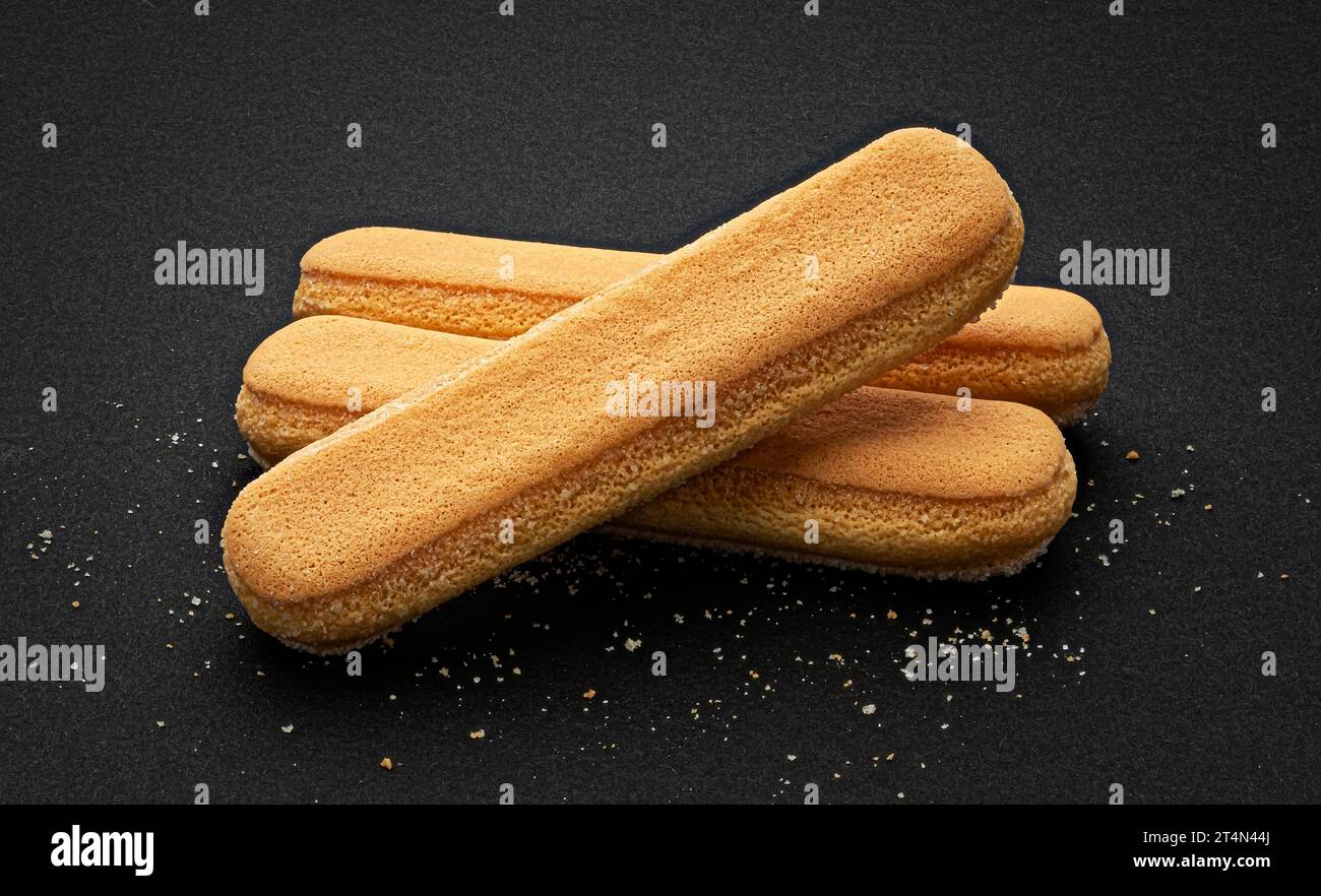 Italian biscuits on black background, ladyfinger cookies, full depth of ...
