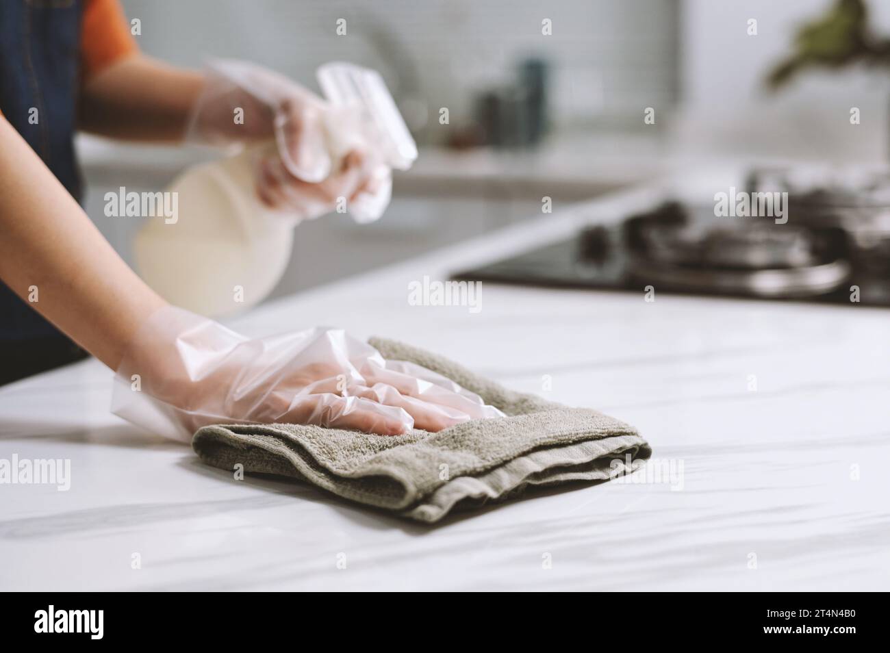 Closeup image of person wiping kitchen counter with cotton towel Stock ...