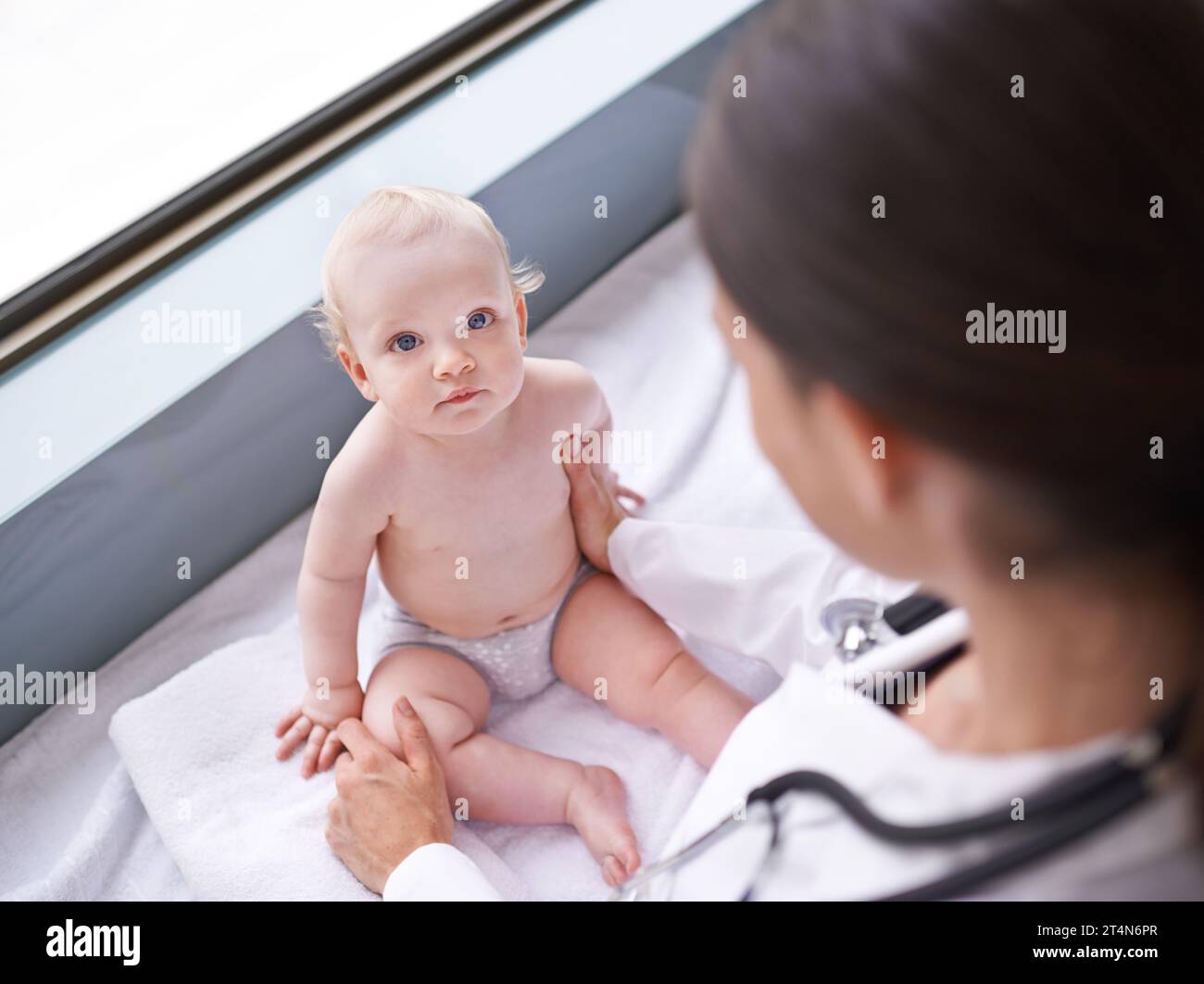 Having his very first checkup. a female doctor doing a checkup of a ...