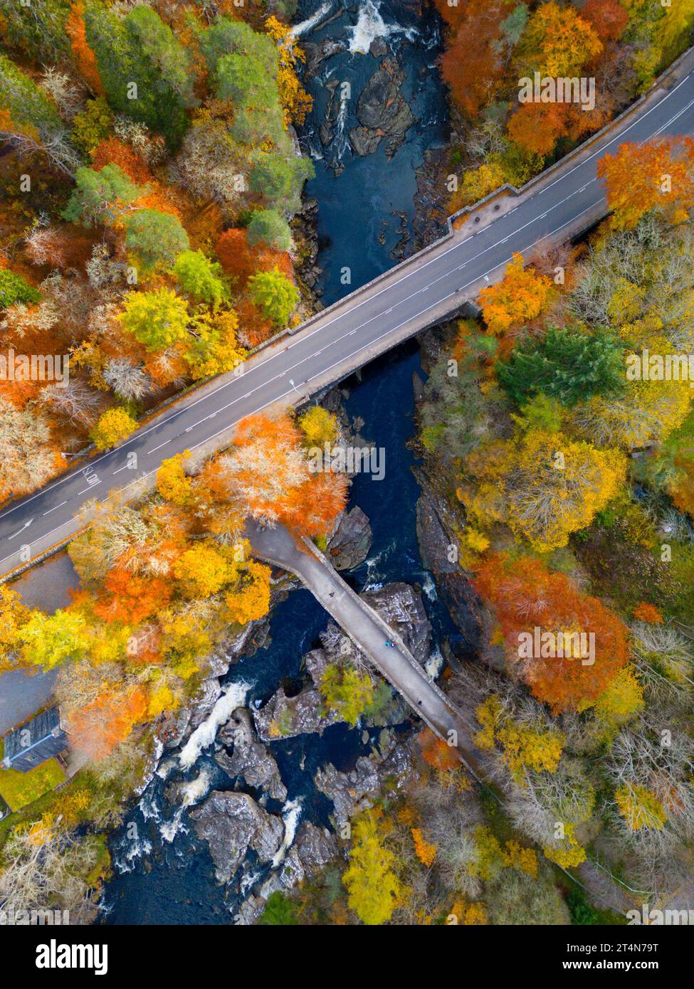 Aerial view of old and new bridges crossing River Moriston surrounded ...