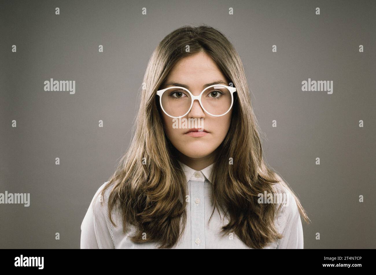 Always underestimated as a woman. a young woman wearing retro glasses ...