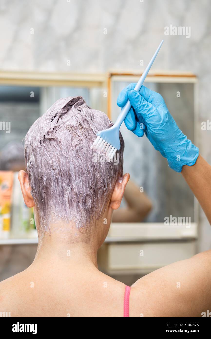 Moscow, Russia - October 16, 2023: woman dyeing her hair at home. woman ...