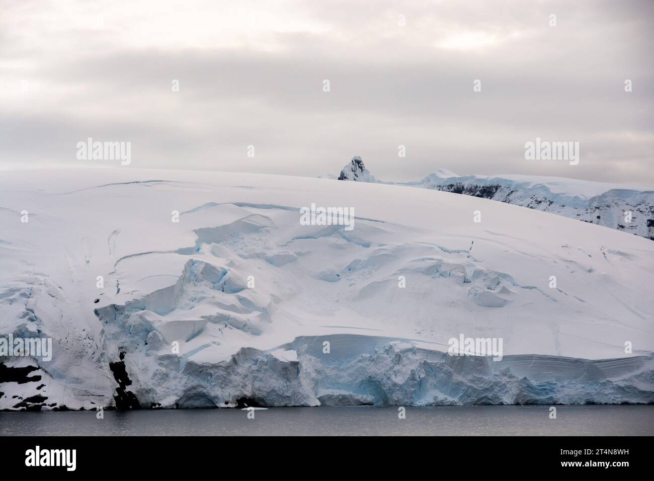 snow covered ice cliffs of island of antarctic peninsula. antarctica ...