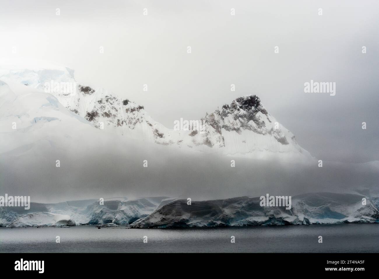 amazing clouds over snow covered mountains of danco coast. charlotte ...