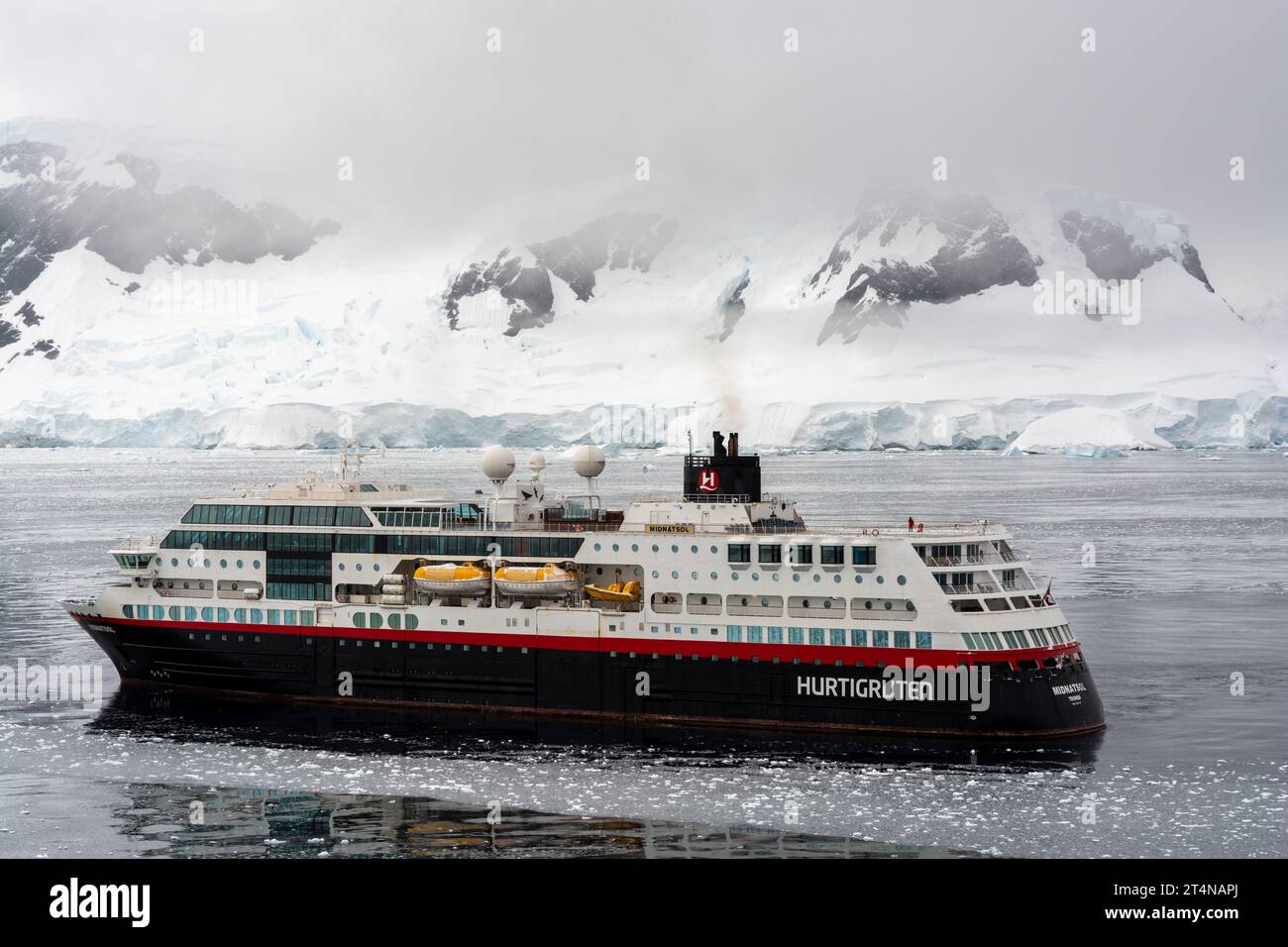 hurtigruten cruise ship and zodiacs operating in icy waters of ...