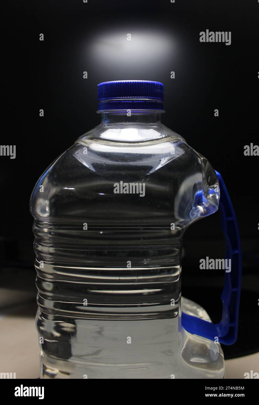 Huge plastic bottle with drinking water on a black background Stock ...