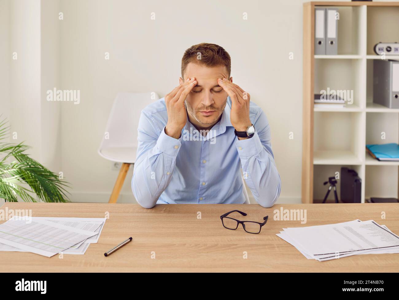 Stressed, tired, overworked business man suffering from headache at ...