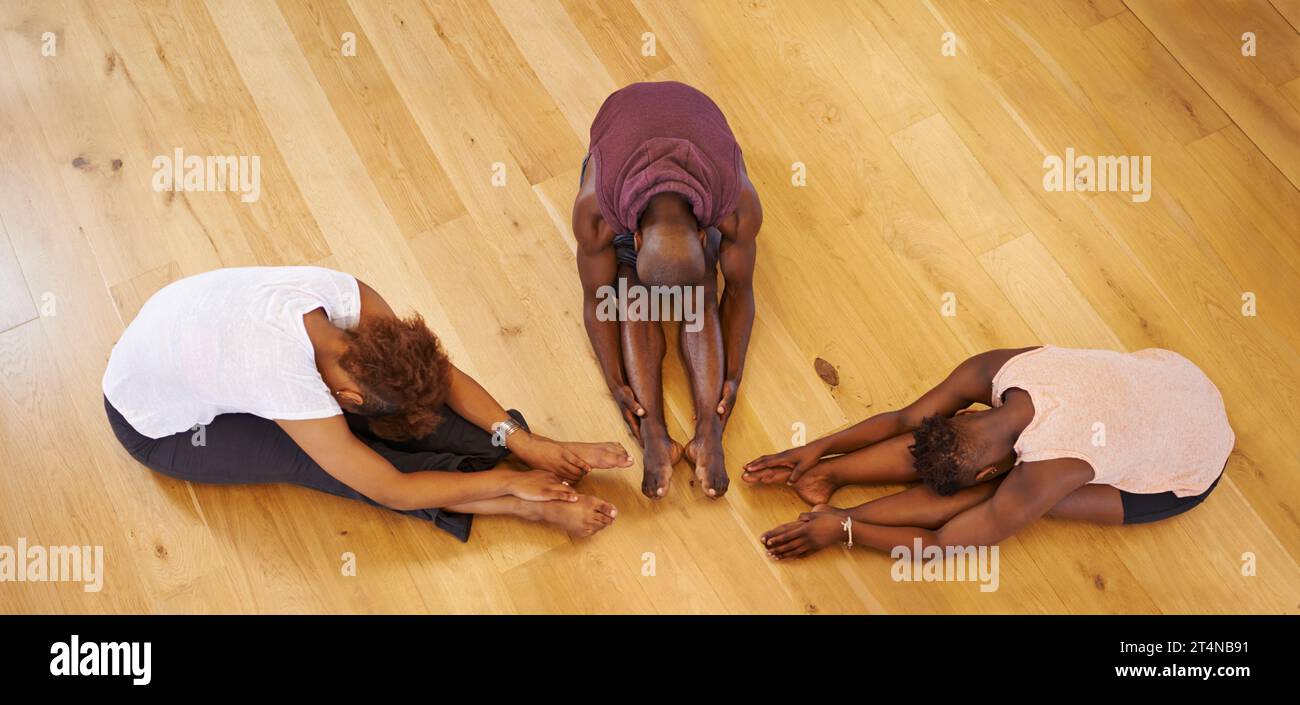 Stretching soothes the soul. High angle shot of a group of young ...