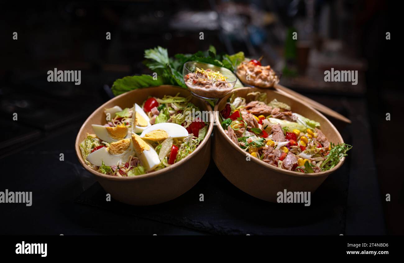 Different types of salads in a bowl on black background Stock Photo - Alamy