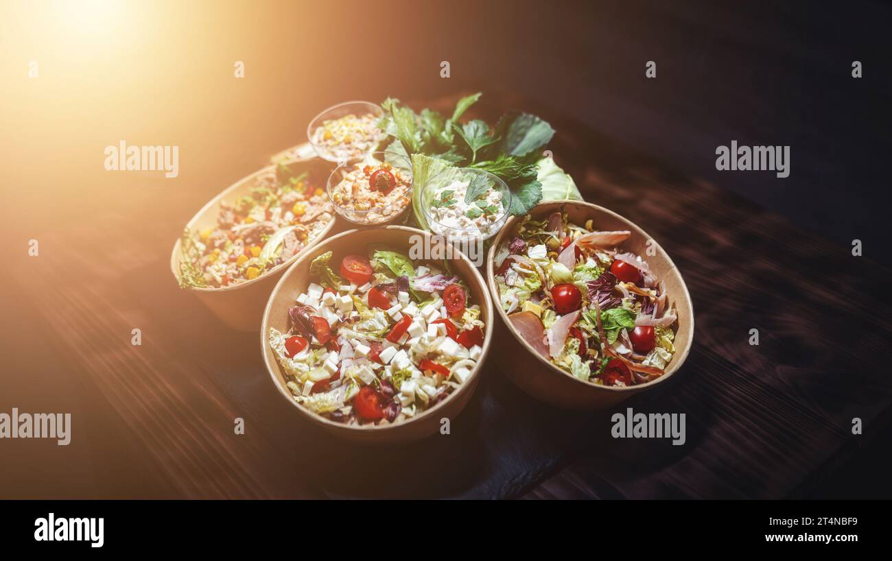 Different types of salads in a bowl on black background Stock Photo - Alamy
