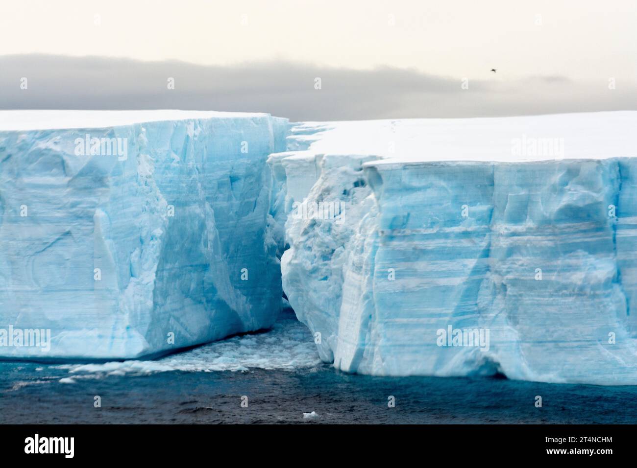 close-up of split in large tabular iceberg in waters of antarctic ...