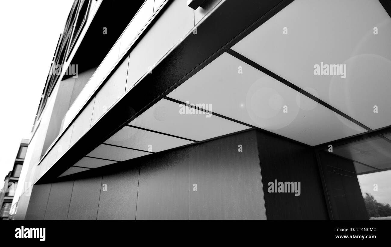 A view at a straight facade of a modern building with a dark grey ...
