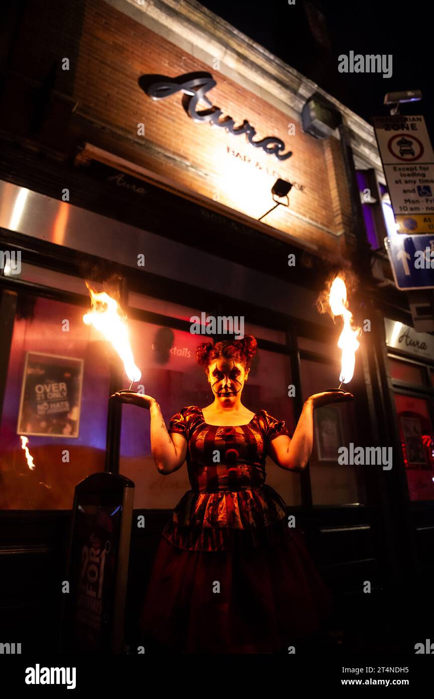 woman performs fire breathing and eating during the halloween weekend ...