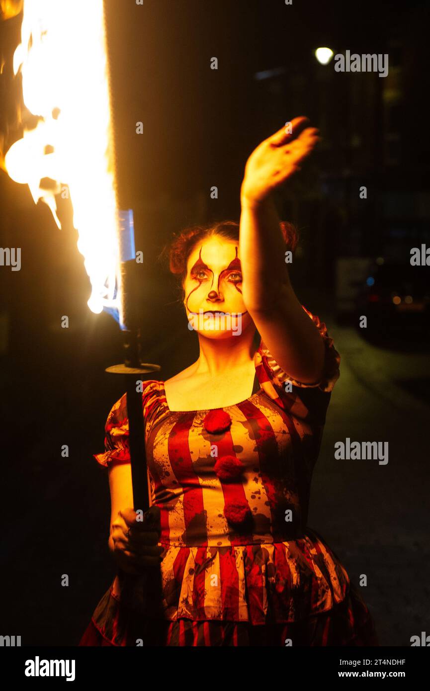 woman performs fire breathing and eating during the halloween weekend ...