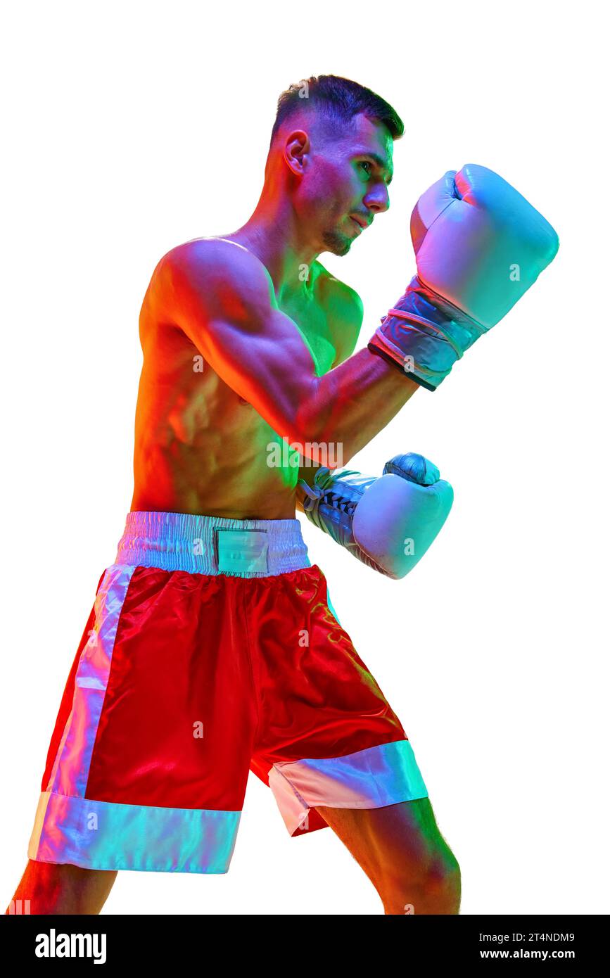 Side view portrait of sportsman, boxer, fighter exercising before fight ...