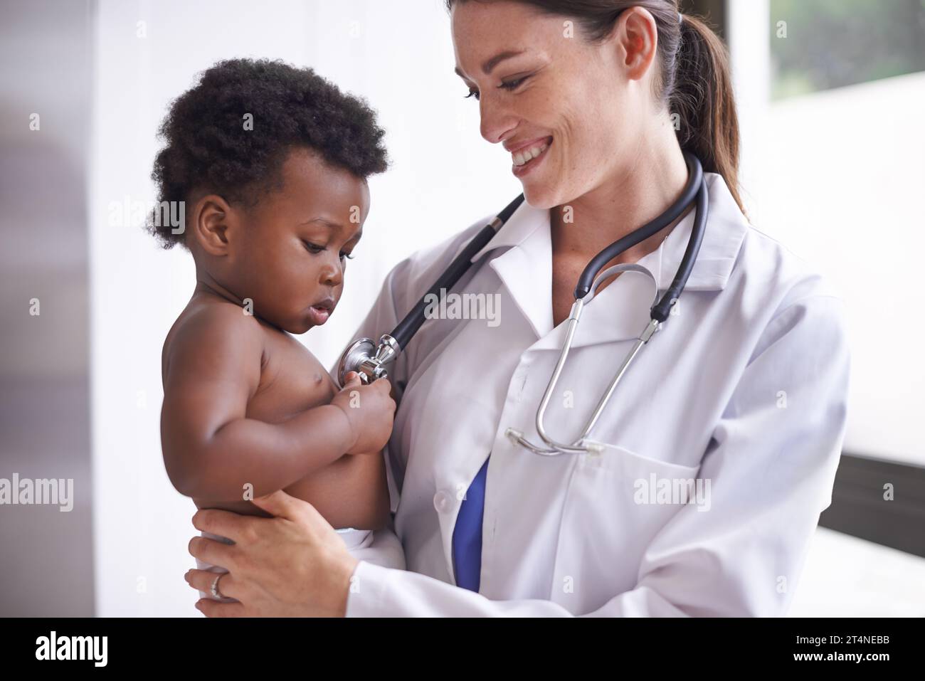 Just in for a routine pediatric checkup. a female pediatrician doing a ...